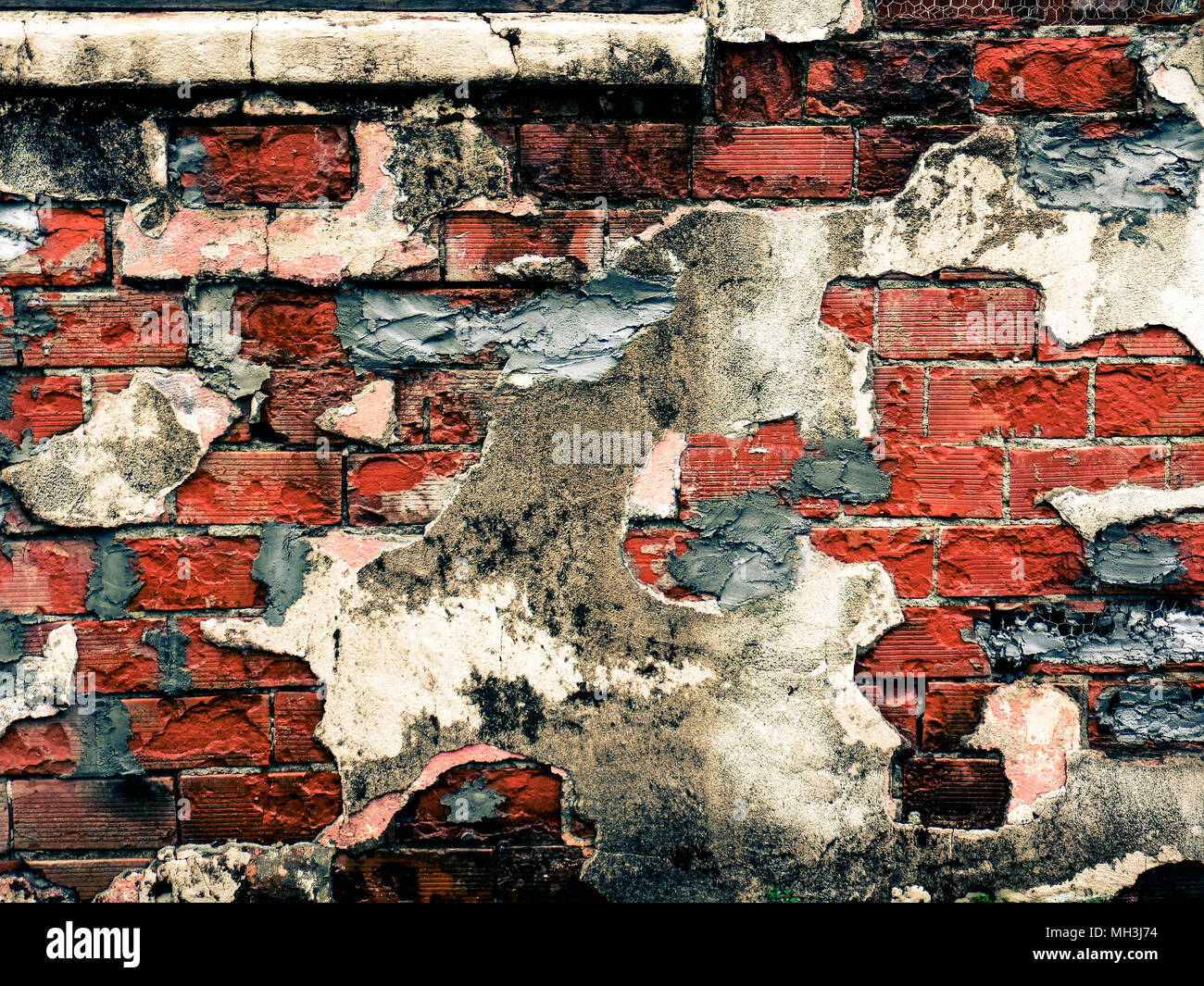 Distressed brick wall with cracks and broken plaster with chipped ...