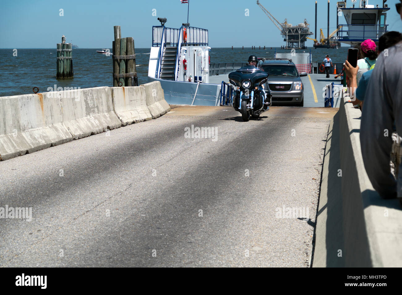 Motorcycle disembarking from Mobile Bay ferry at Fort Morgan dock Stock ...