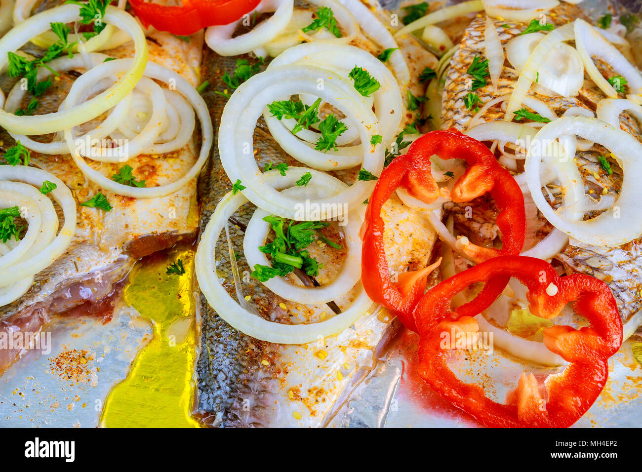marinade is applied to a piece on a slate stone on a metallic ...