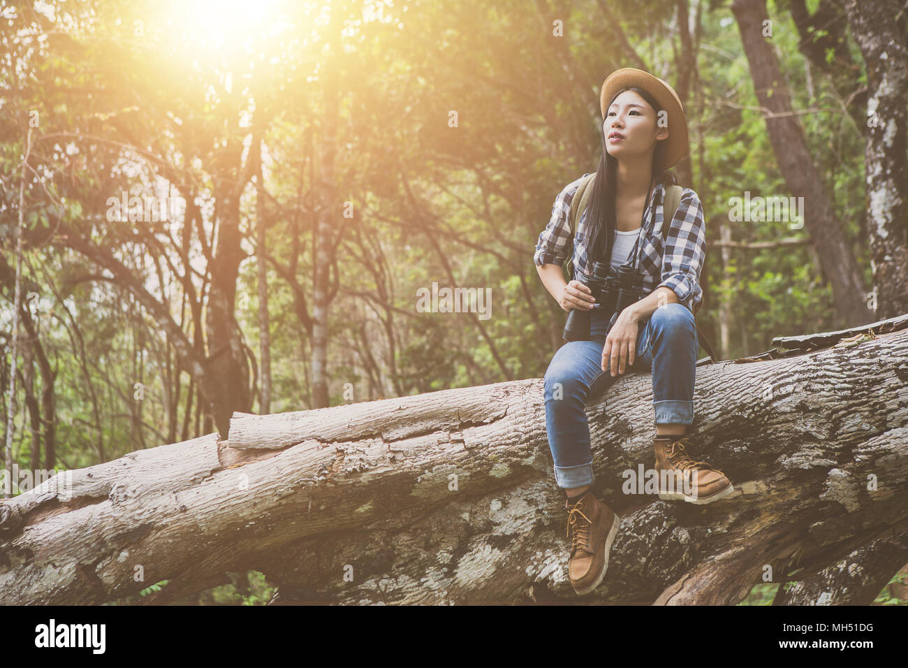 Young woman hiker with backpack watching trekking map, Hiking concept ...