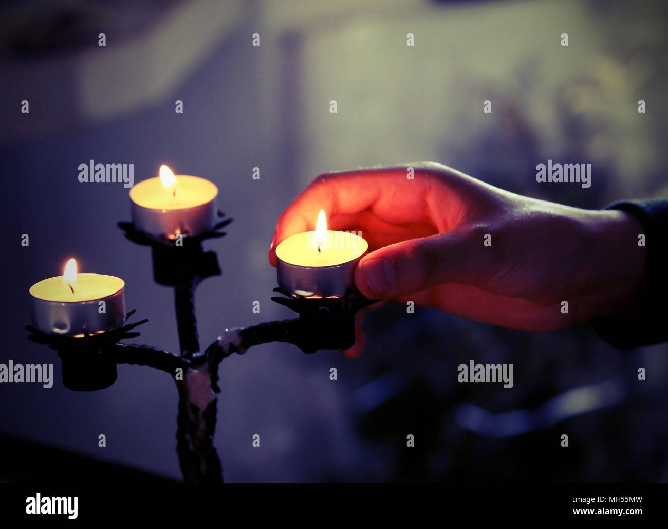 hand of a boy and three candles with vintage effect Stock Photo - Alamy