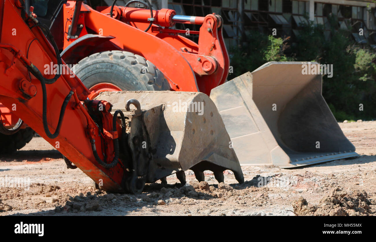 big bulldozers in the construction site with digger buckets Stock Photo ...