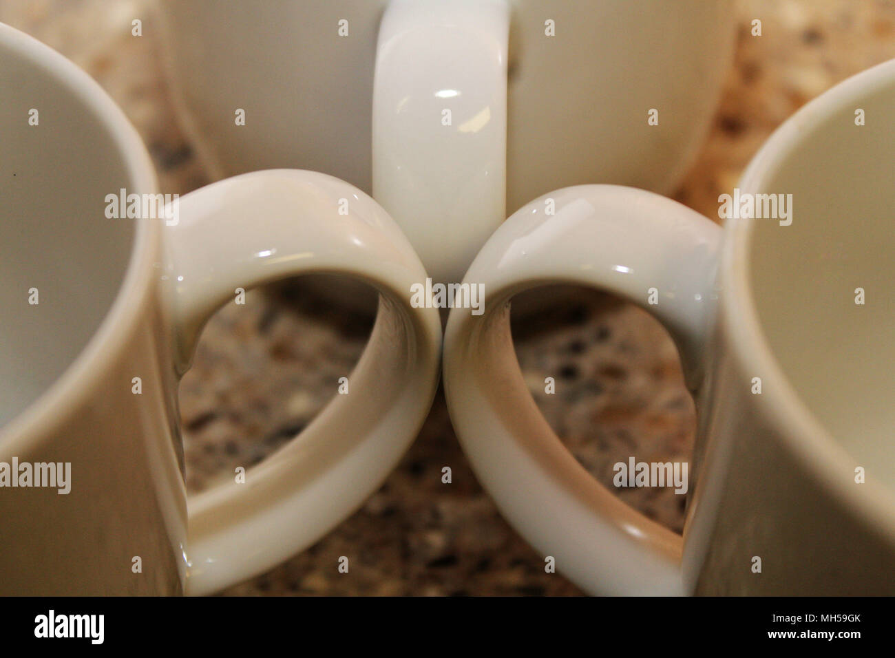 three coffee cup handles touching each other Stock Photo - Alamy