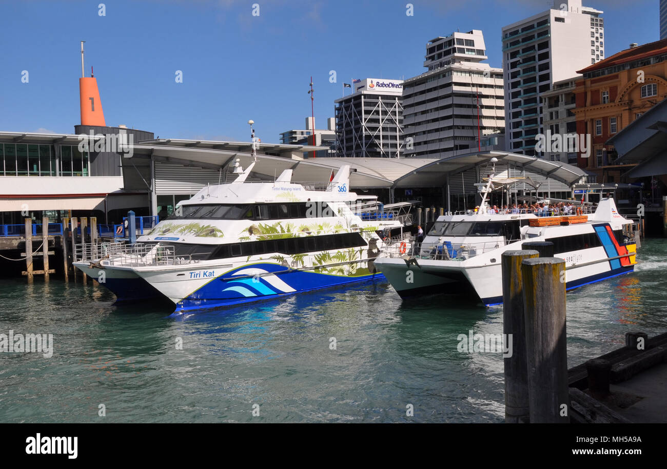 Auckland, New Zealand - December 02, 2011: Two modern ferry boats leave ...