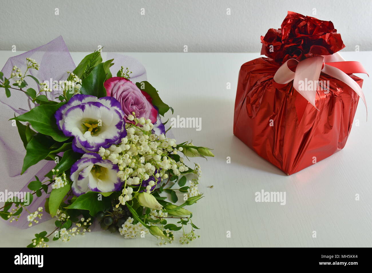 Flowers and gift on white background Stock Photo - Alamy