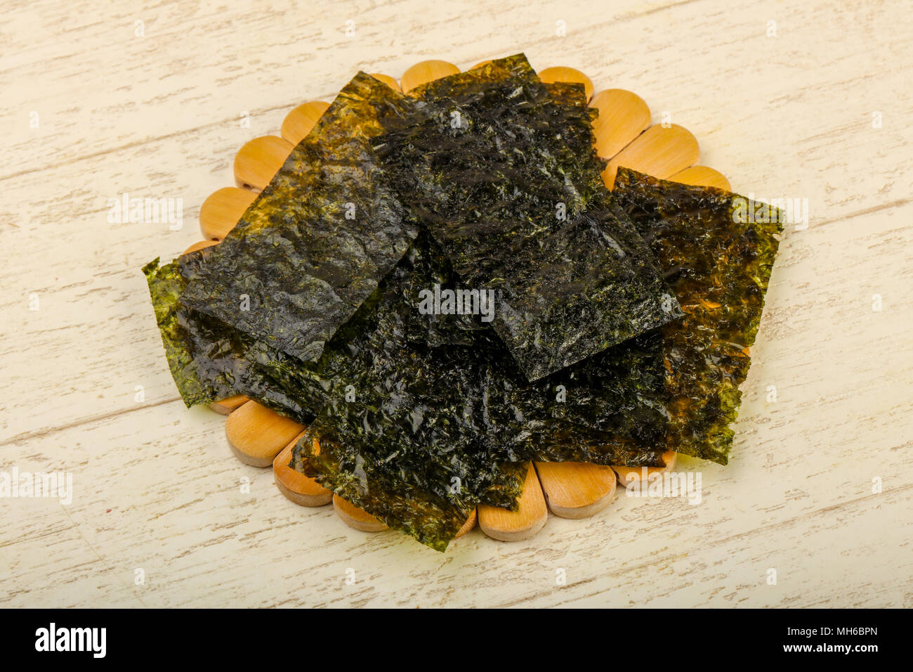 Crispy Nori sheets chips over wooden background Stock Photo - Alamy