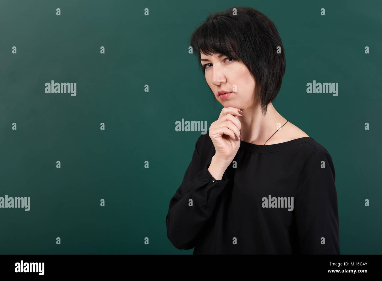 teacher having idea and posing by chalk Board, learning concept, green ...
