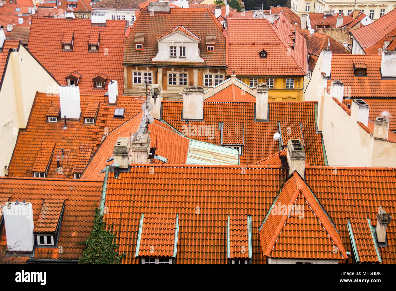 Red roof of buildings in Prague in a cold cloudy fall weather. Old town ...