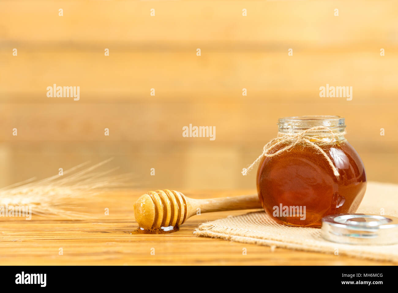 honey and honey comb with wooden stick Stock Photo - Alamy