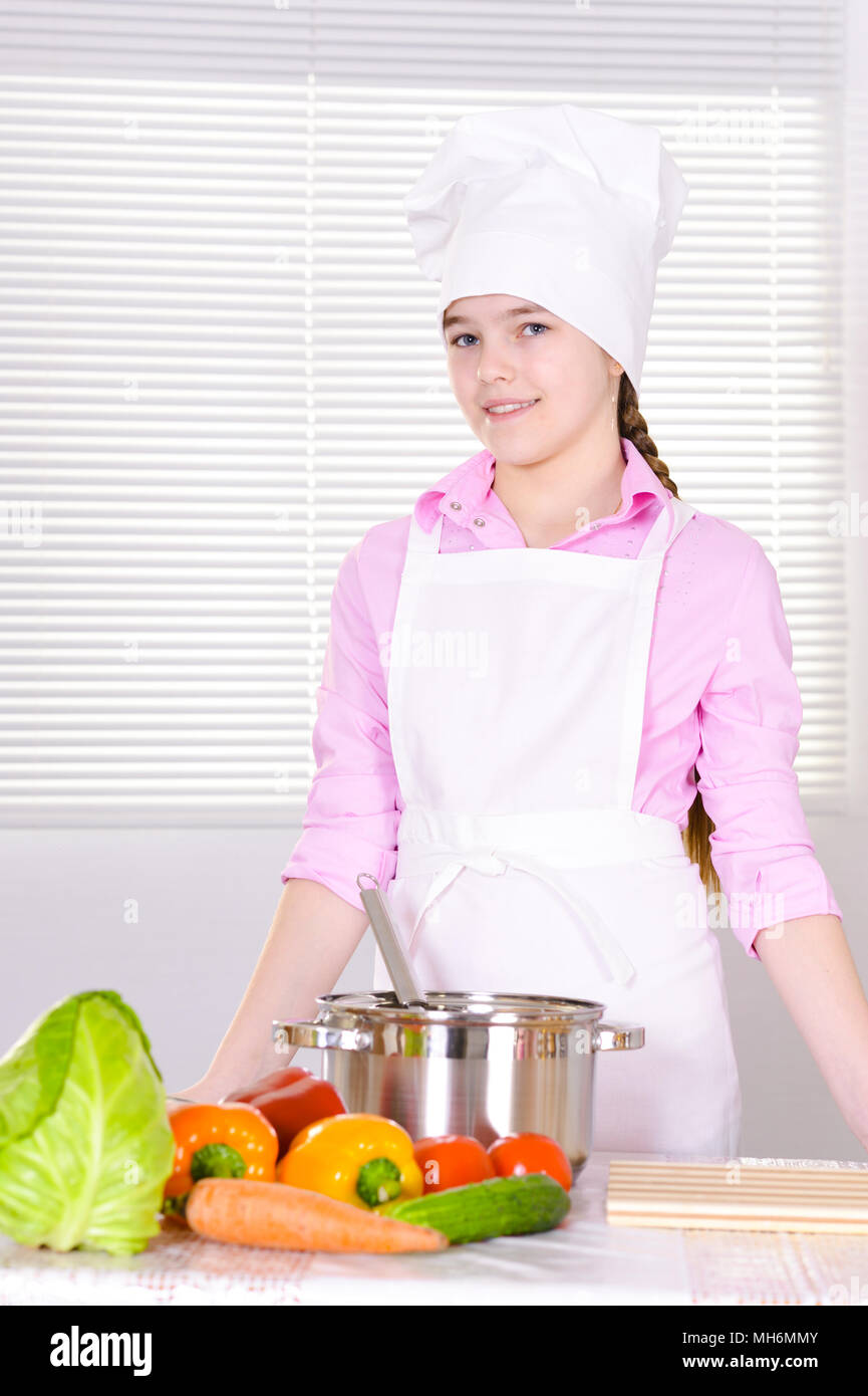 beautiful girl wearing chef uniform cooking Stock Photo - Alamy