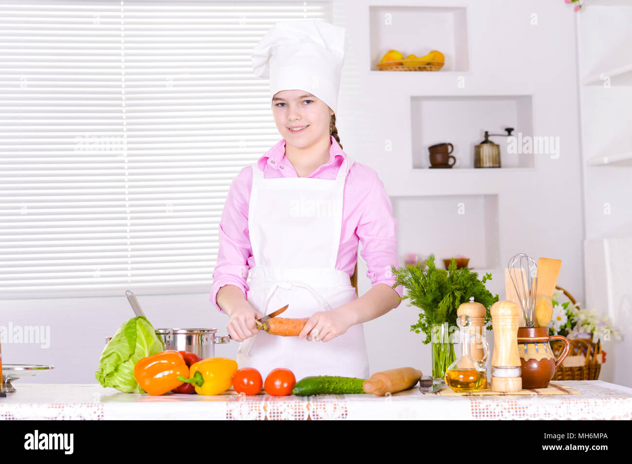 beautiful girl wearing chef uniform cooking Stock Photo - Alamy