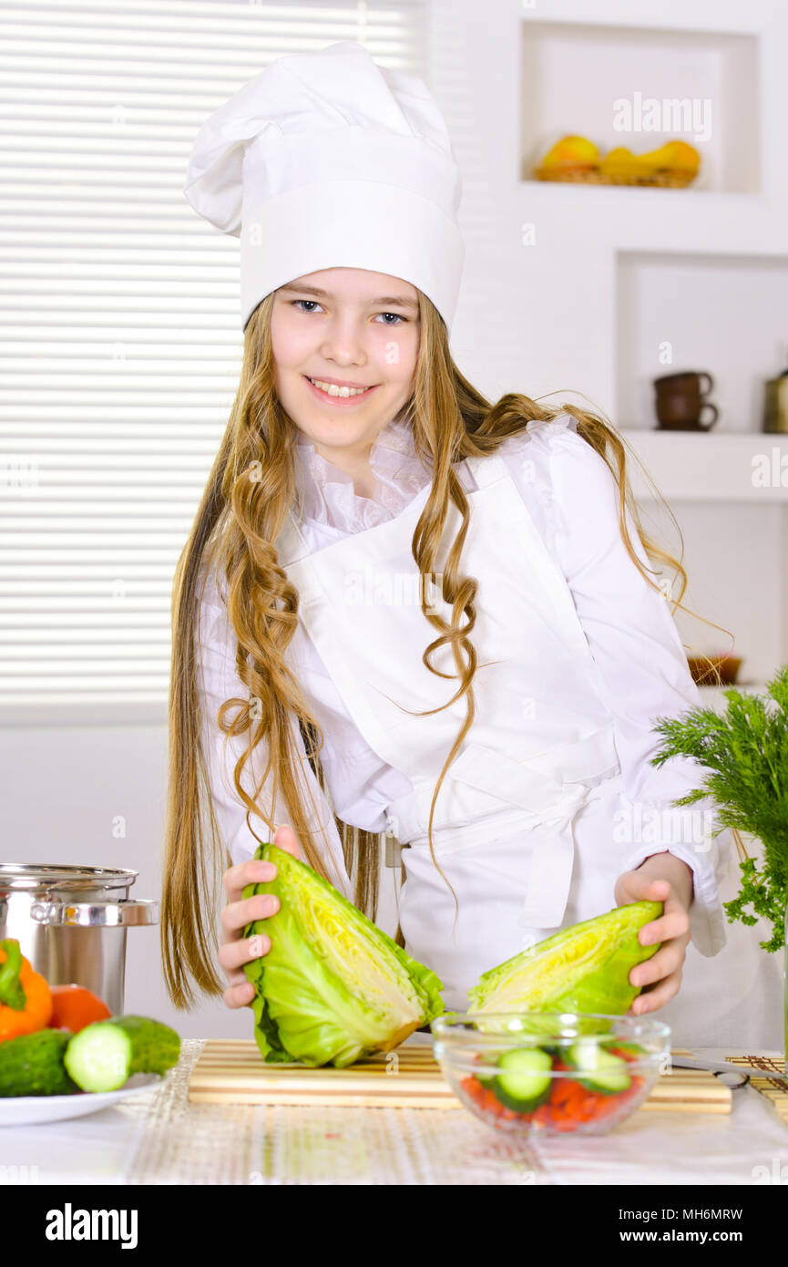 girl wearing chef uniform cooking on kitchen Stock Photo - Alamy