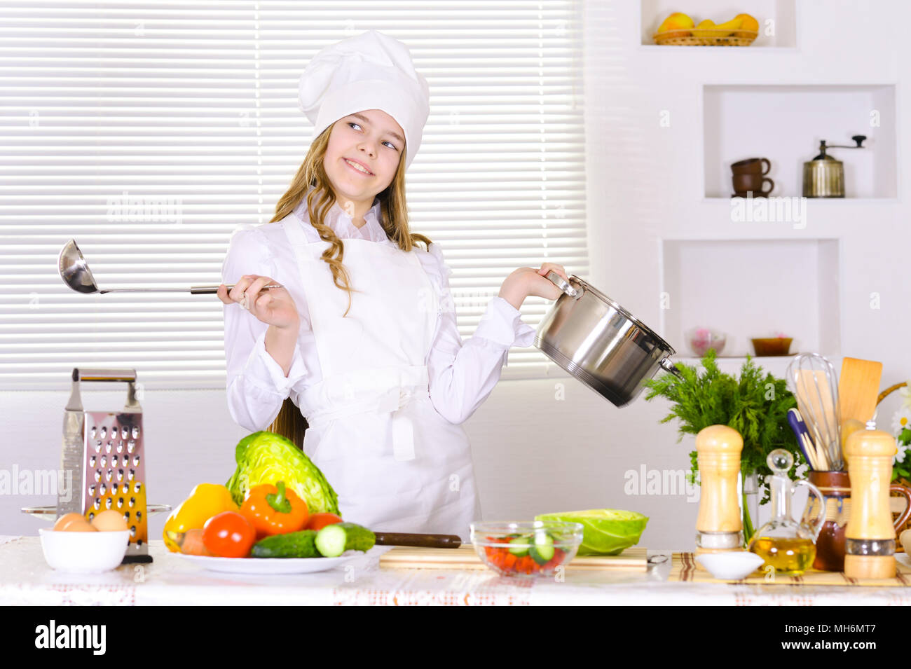 girl wearing chef uniform cooking on kitchen Stock Photo - Alamy