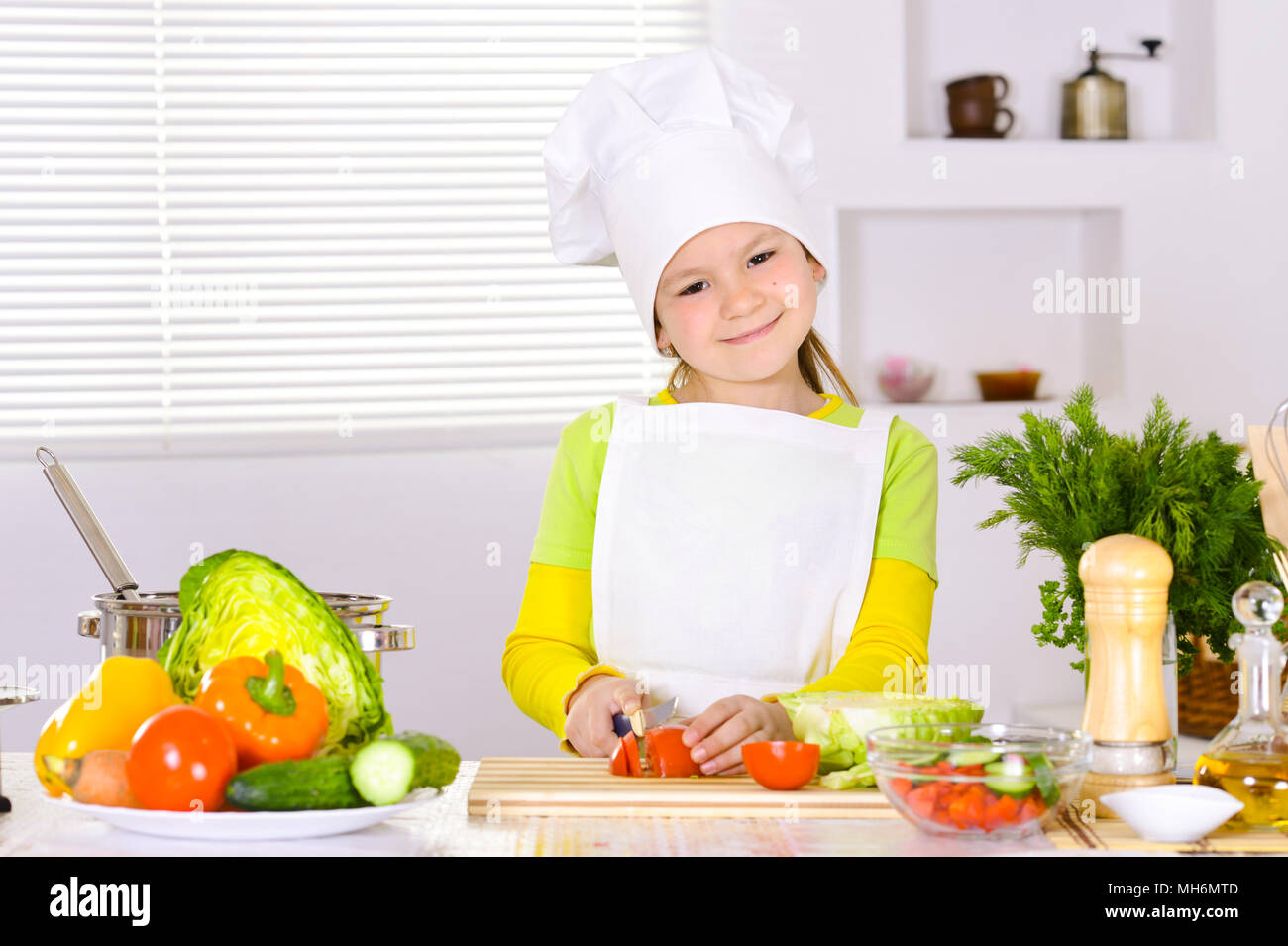 girl wearing chef uniform cooking on kitchen Stock Photo - Alamy