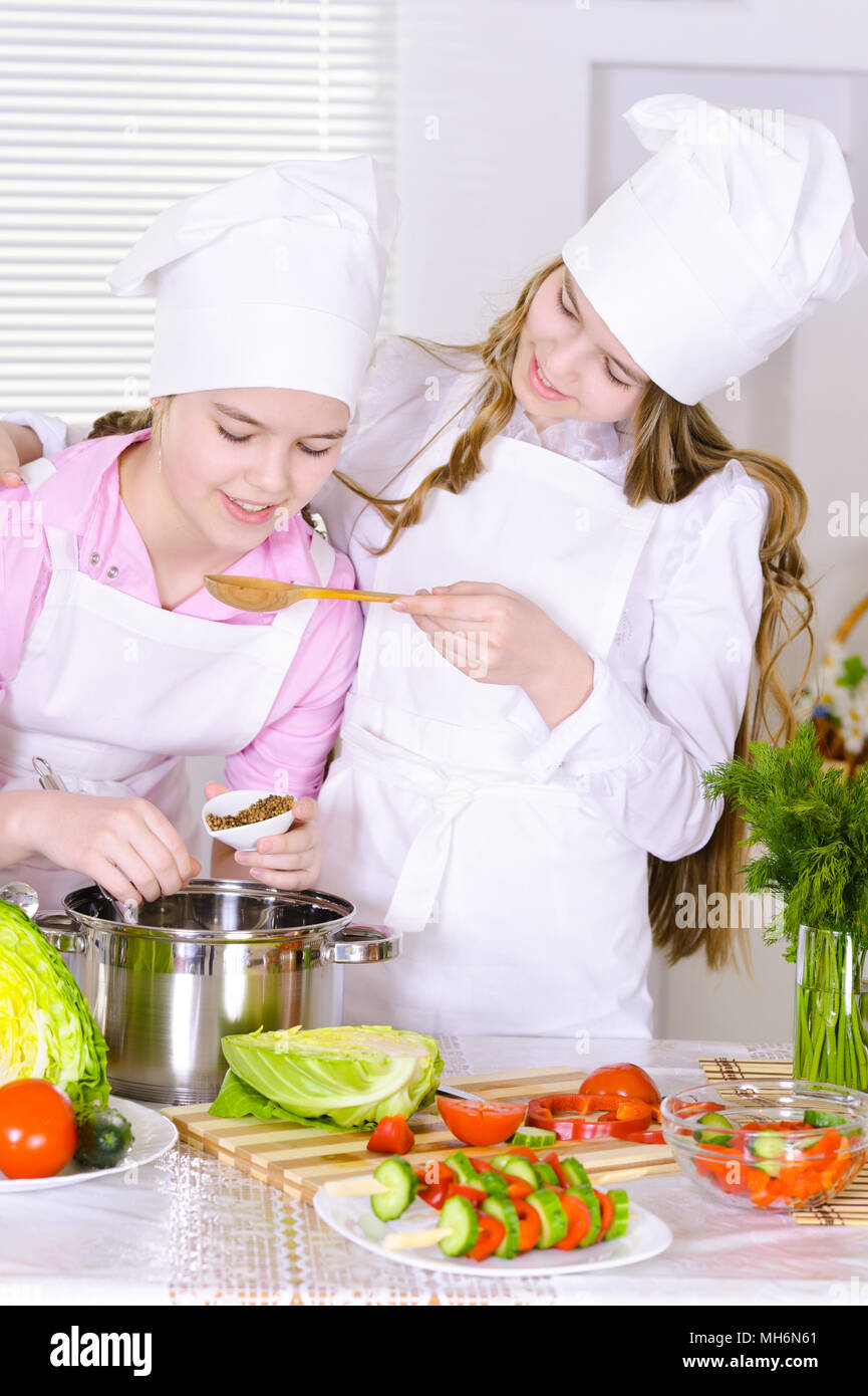 two cute girls cooking Stock Photo - Alamy