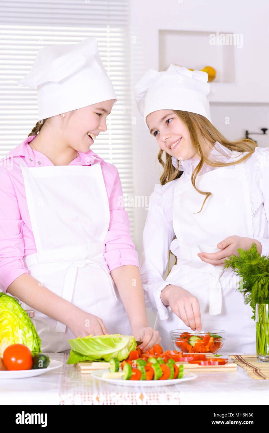 two cute girls cooking Stock Photo - Alamy