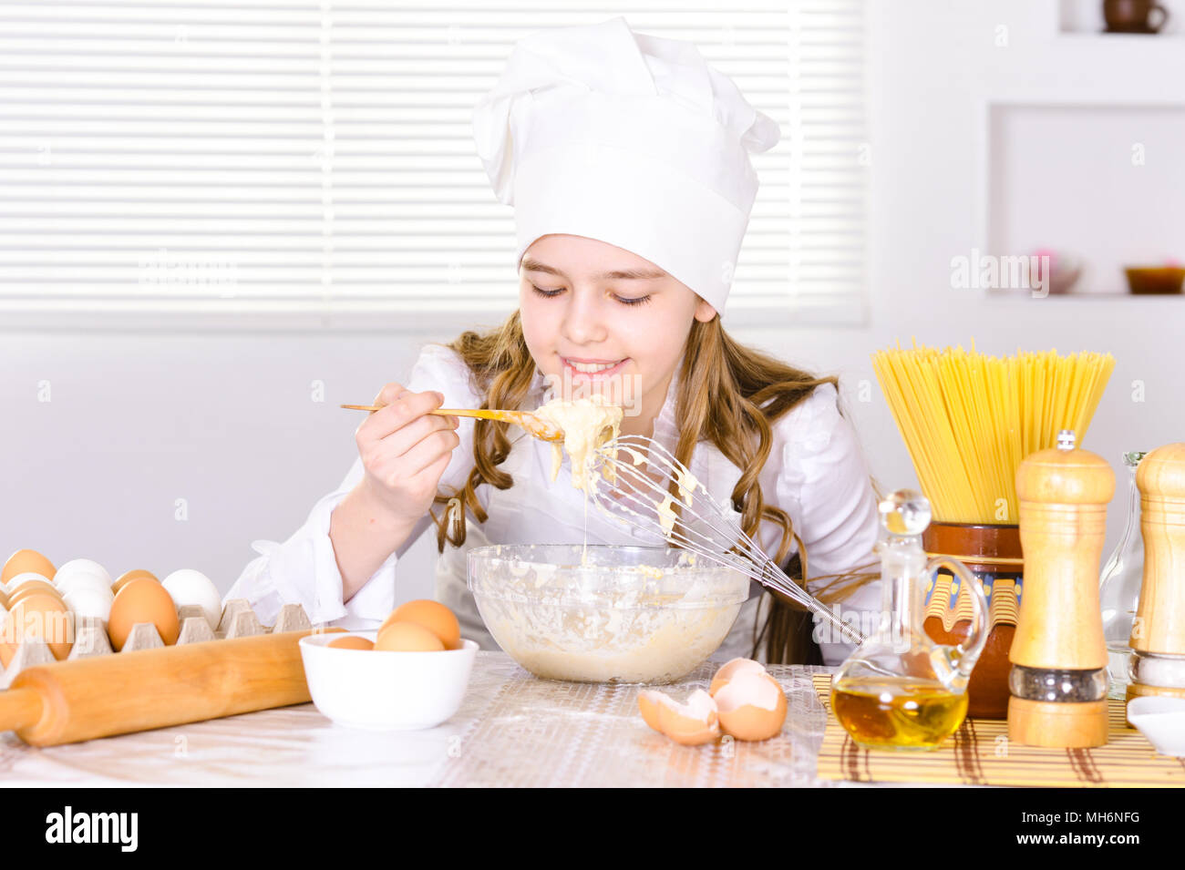 Cute girl cooking in the kitchen Stock Photo - Alamy