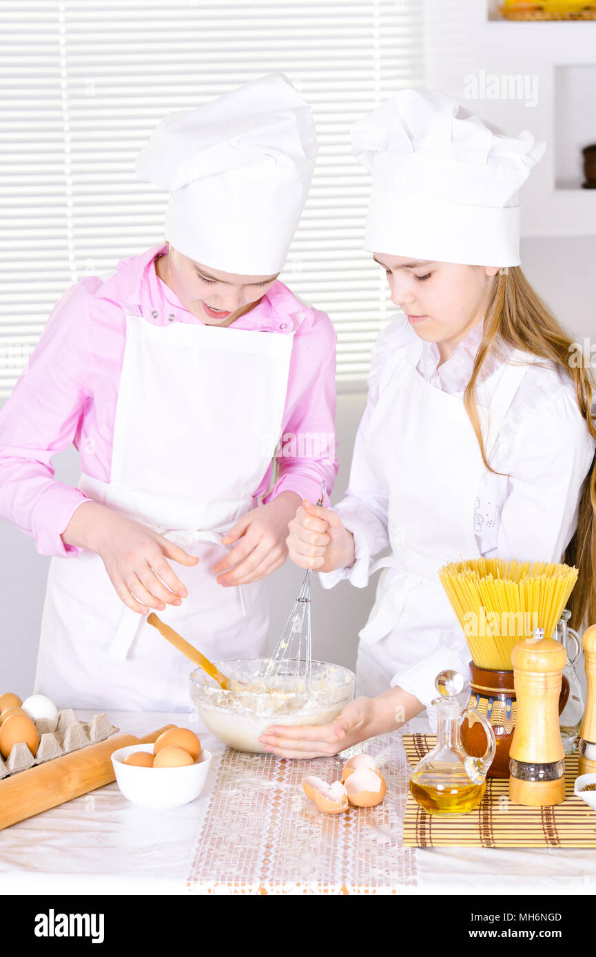 two cute girls cooking Stock Photo - Alamy