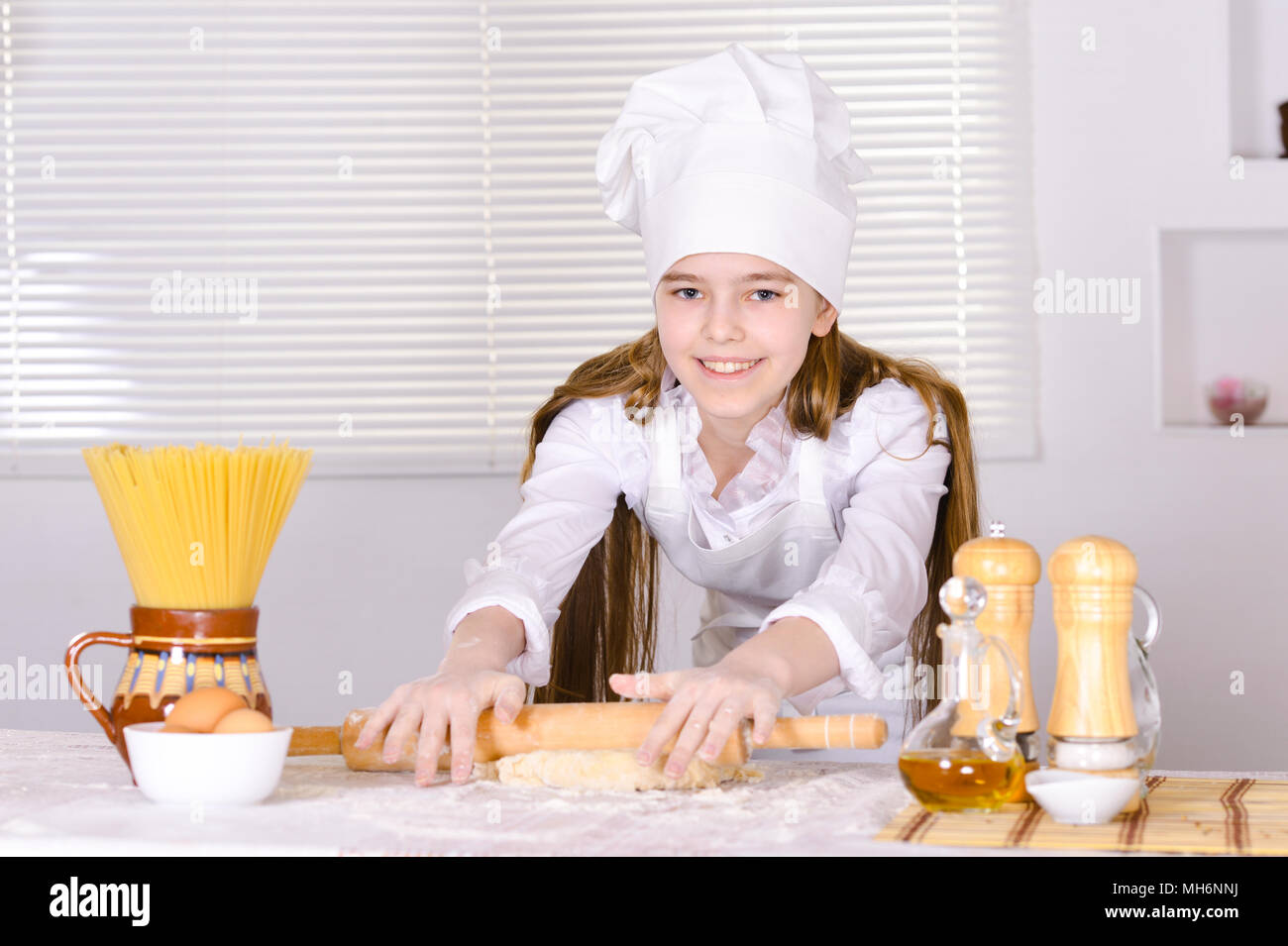 Cute girl baking in the kitchen Stock Photo - Alamy