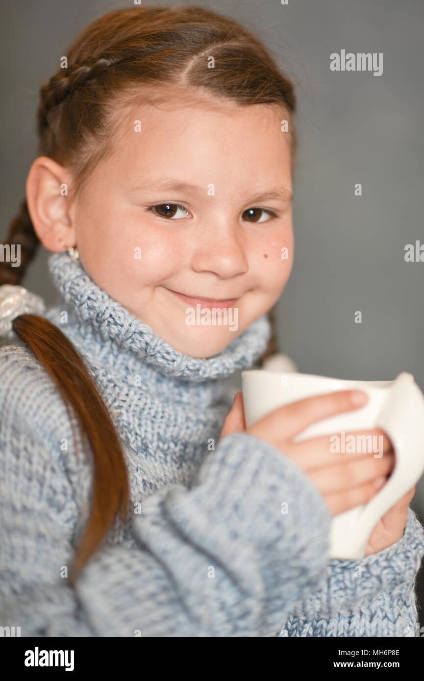 cute sick girl with cup of rea Stock Photo - Alamy