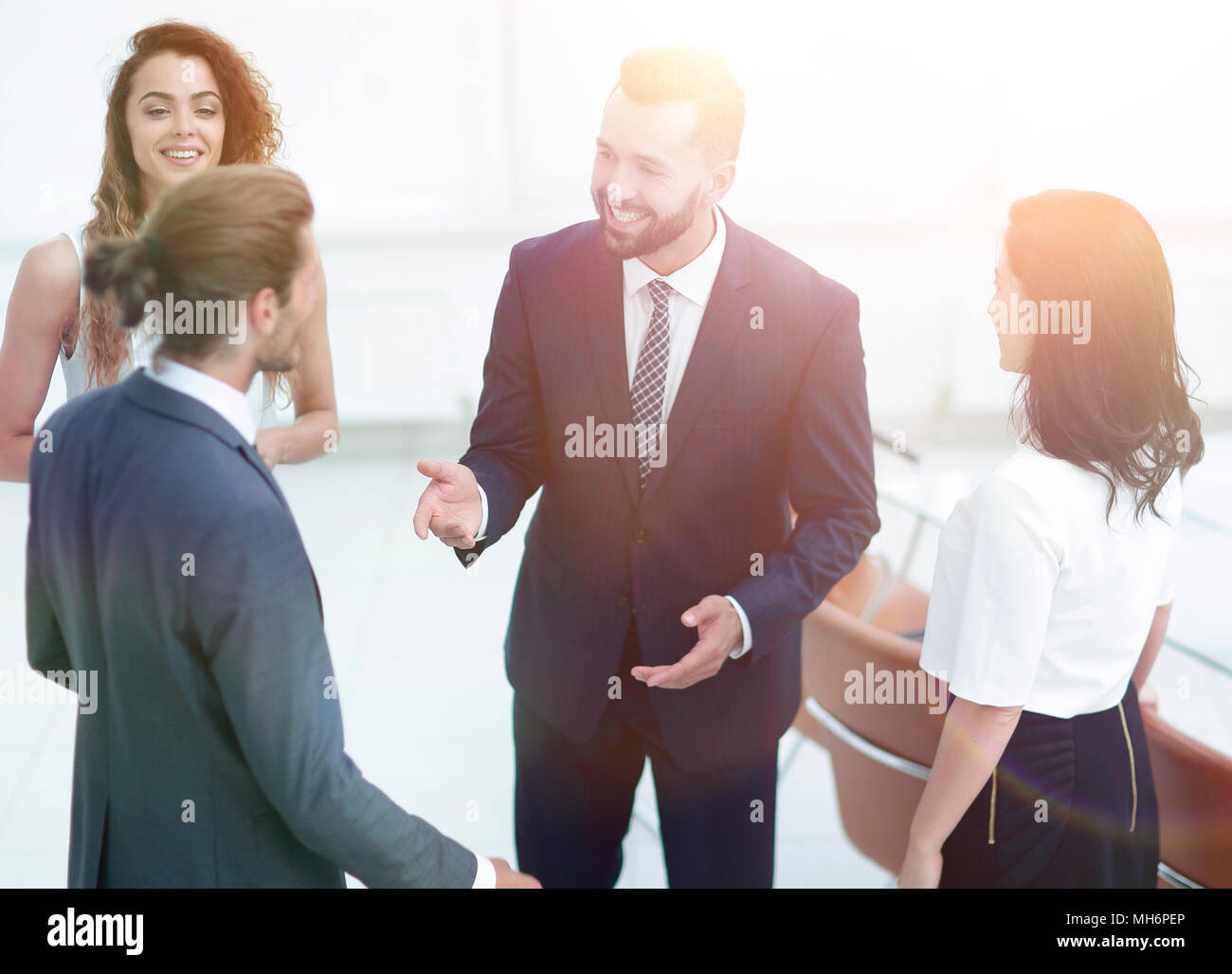 business team talking, standing in office Stock Photo - Alamy