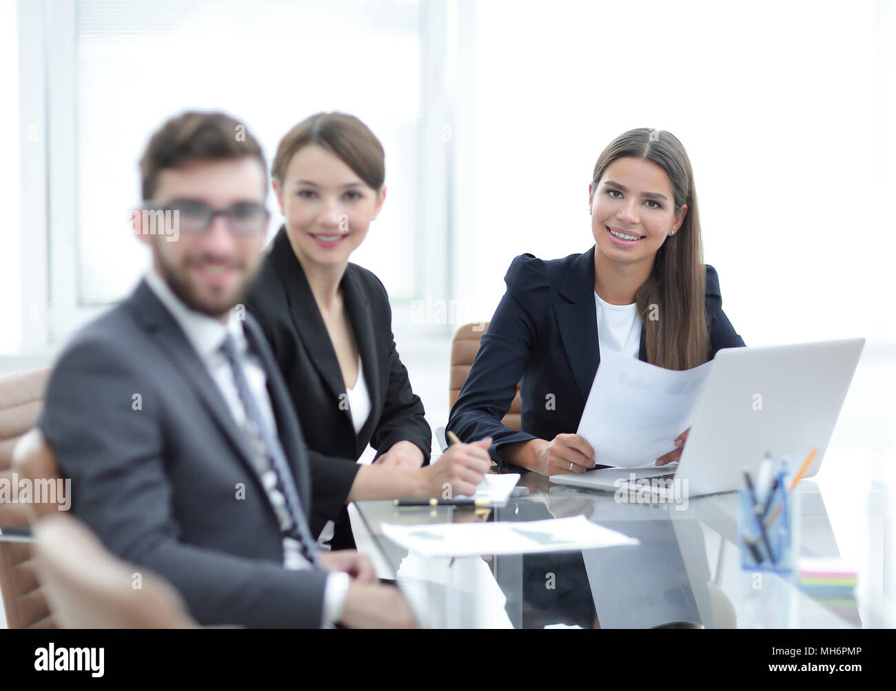 employees sitting behind a Desk Stock Photo - Alamy