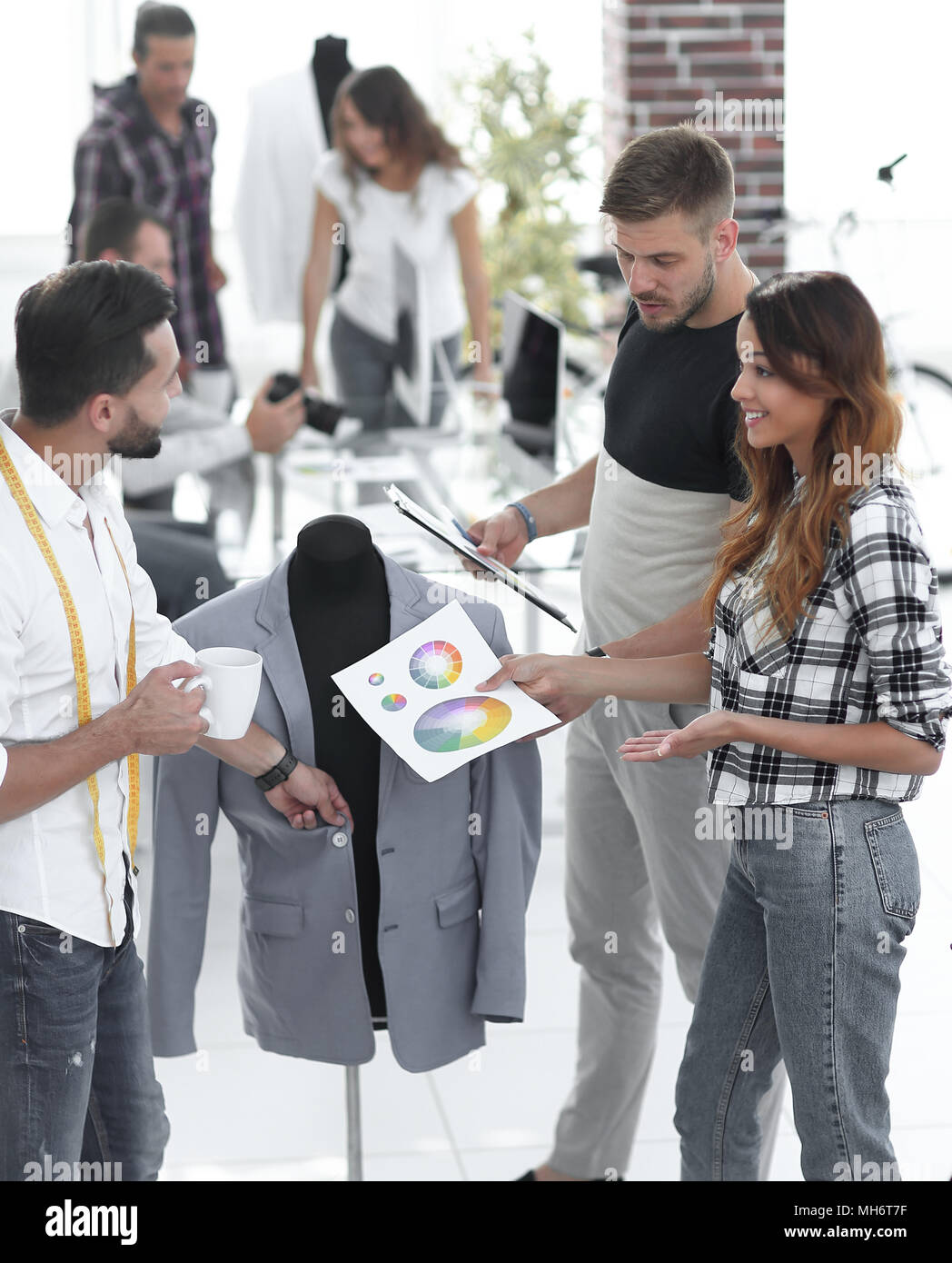 Fashion designers discussing designs hi-res stock photography and ...