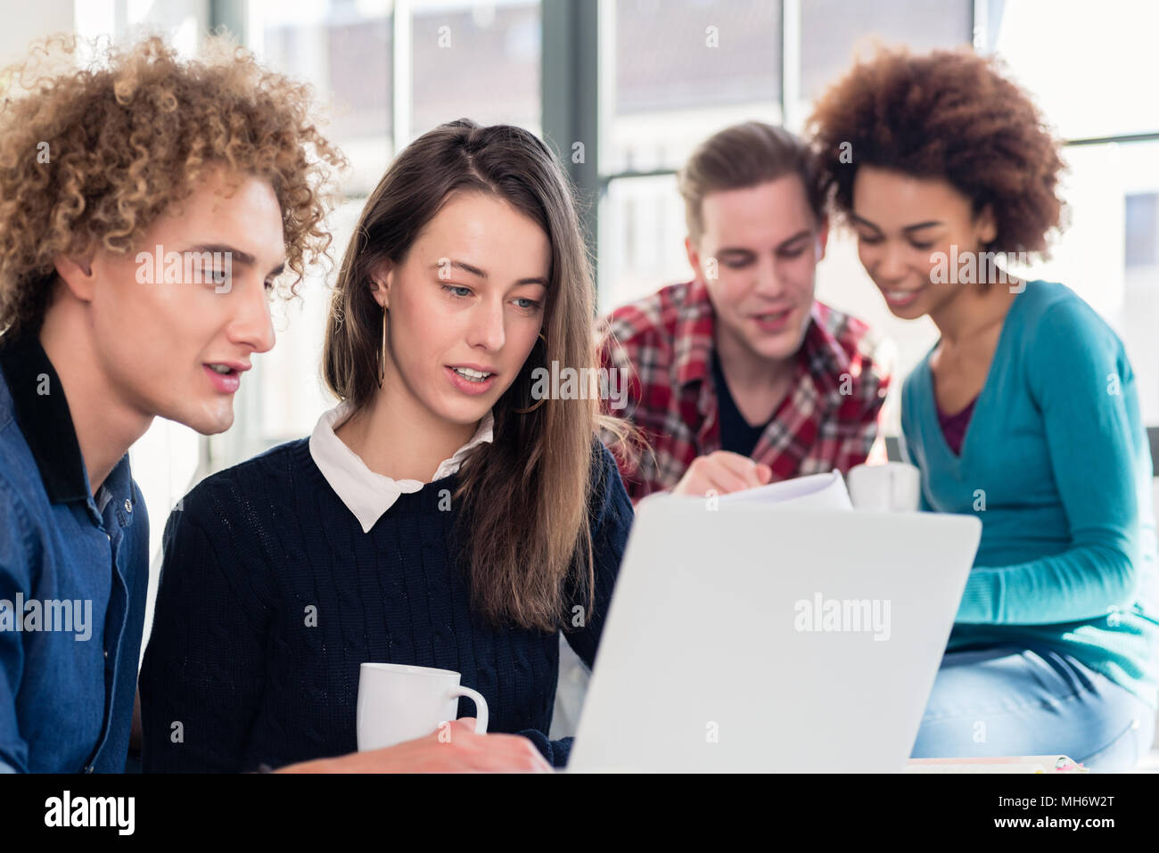 Two young students searching for an answer to their question Stock ...