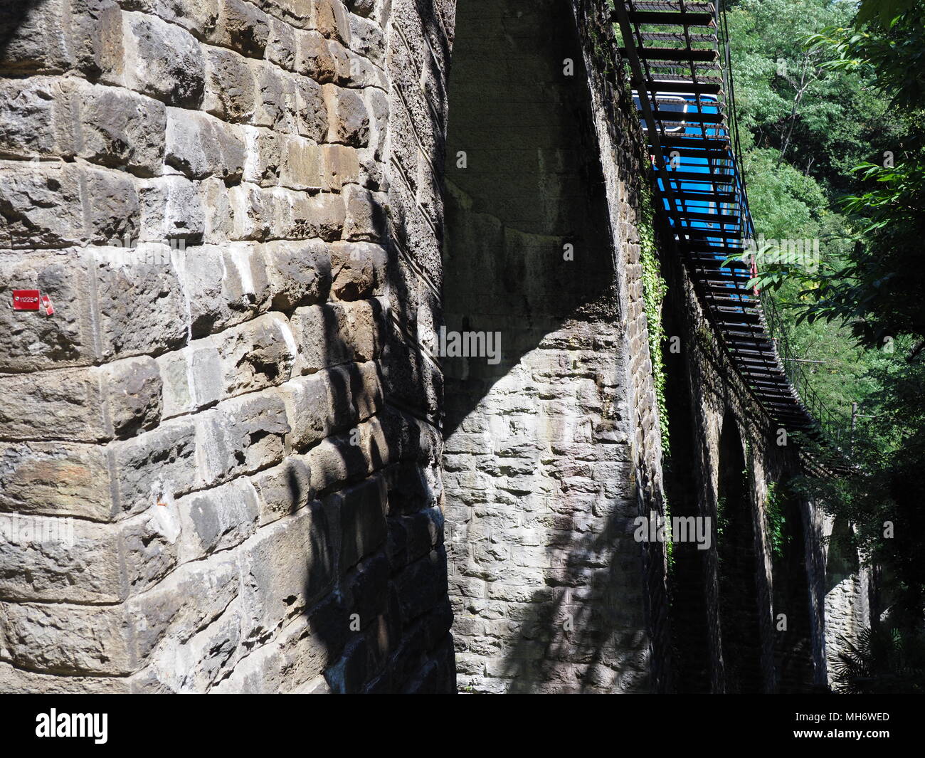 View of stony funicular railway bridge of tourist train in european ...