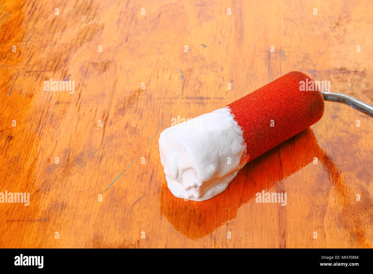 paint roll brush in white paint on plywood surface Stock Photo - Alamy