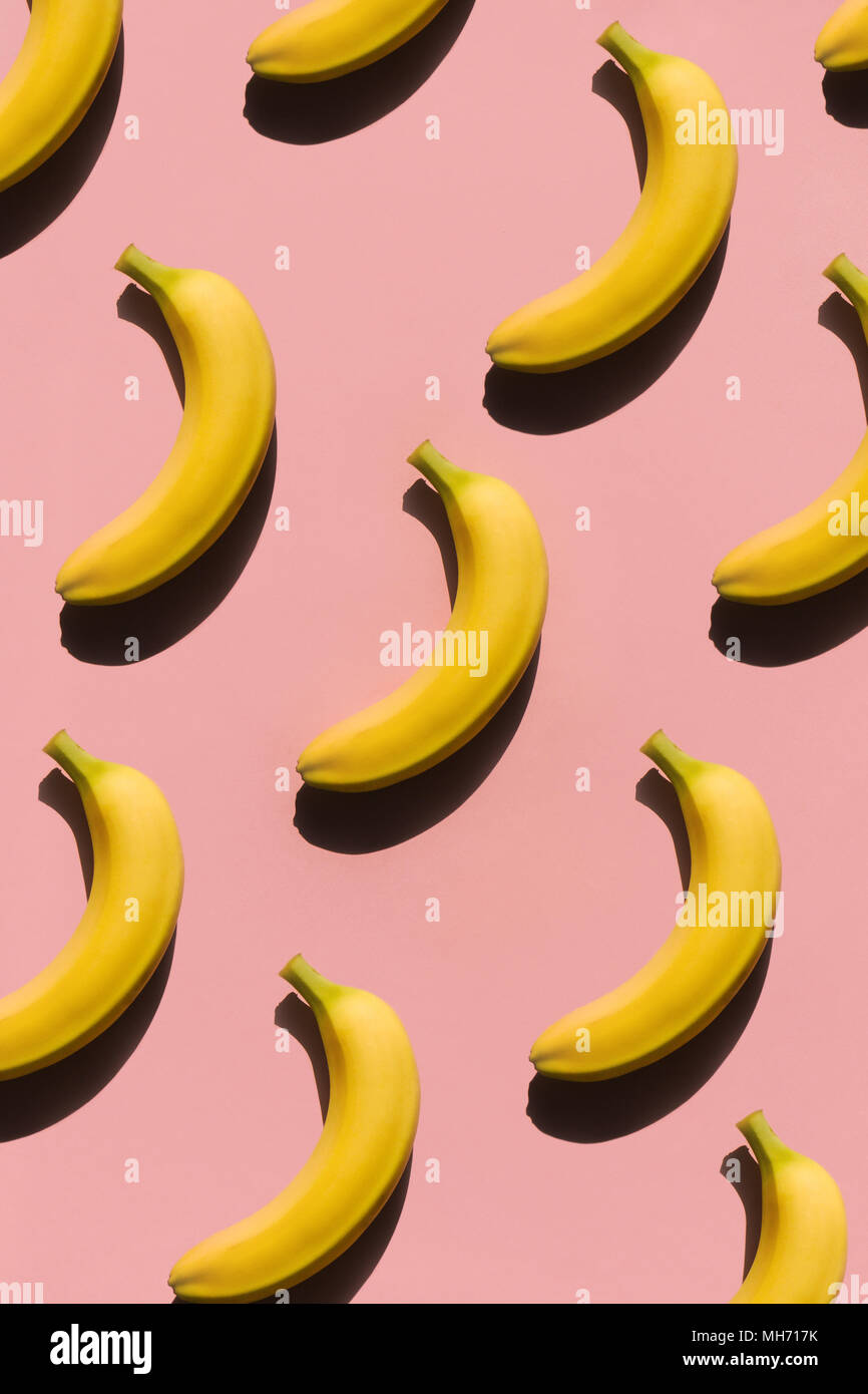 Flat lay of arranged yellow bright bananas in seamless pattern on light ...