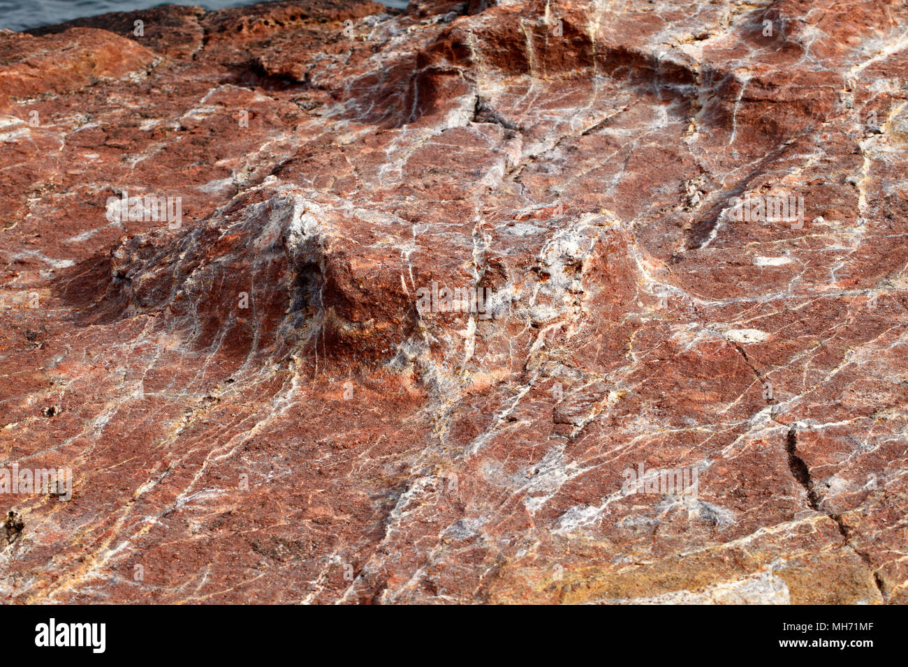 Red sandstone rocks with quartz veining Stock Photo - Alamy
