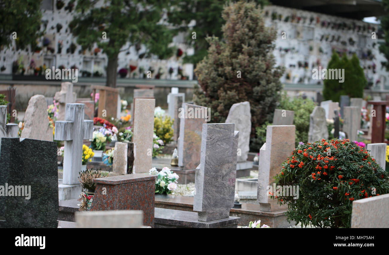 inside a cemetery with many tombs and tombstones without people but ...