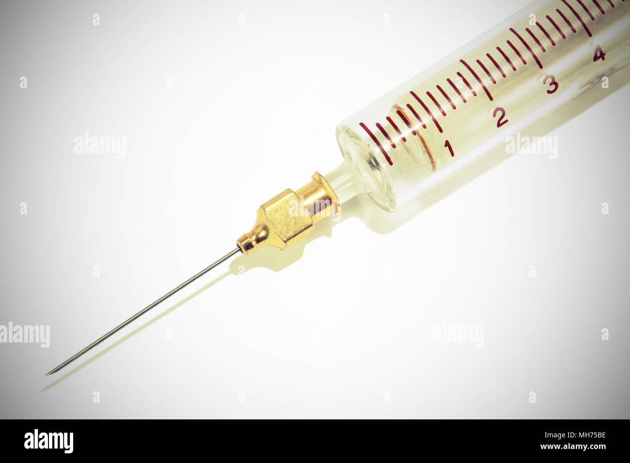 medical syringe made of glass on vintage background with a needle for ...