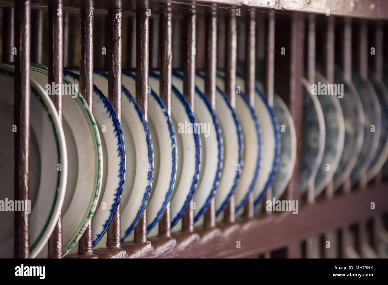Old Victorian plates in vertical wooden plate rack in Victorian mansion ...
