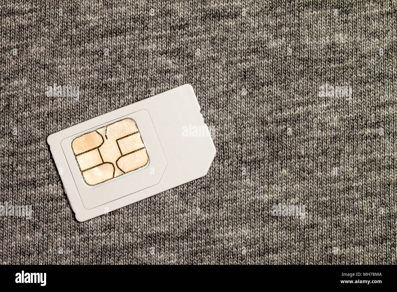 Simcard isolated on grey cloth texture background Stock Photo - Alamy