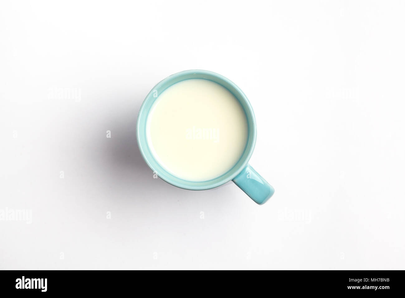 Milk in a blue cup isolated on white background, top view Stock Photo ...