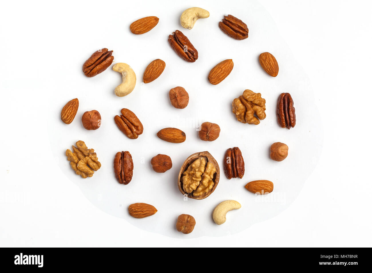 Different kinds of nuts laid out in the shape of circle, isolated on ...