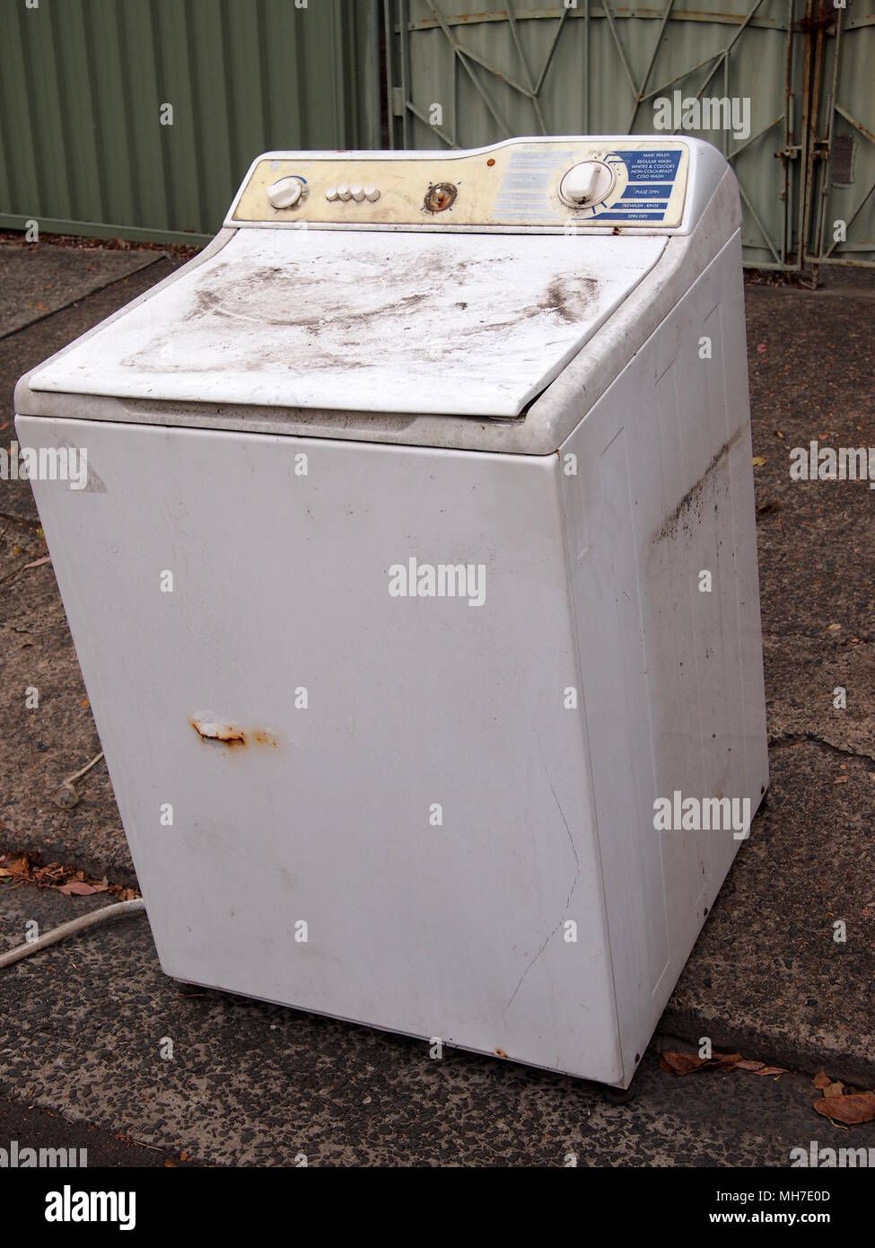 Old dirty washing machine on side of road Stock Photo - Alamy