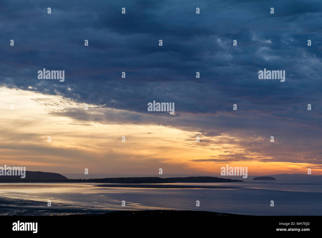The setting sun lighting up the horizon Stock Photo - Alamy