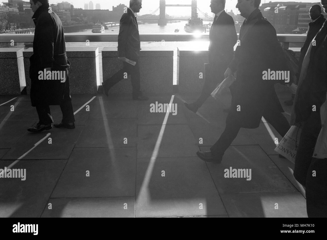 Commuters walking across London Bridge. Office workers going to work in ...