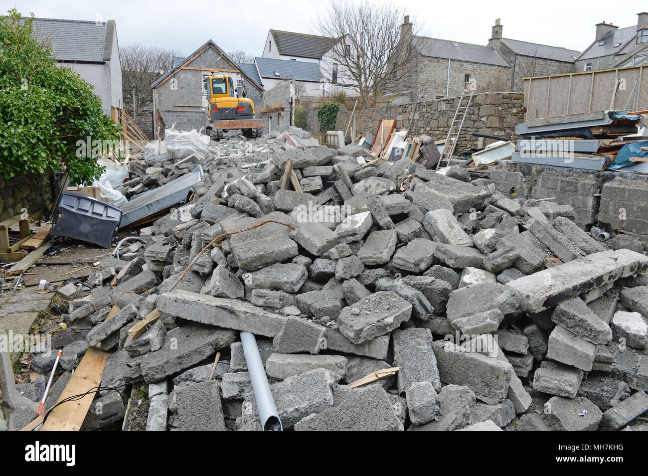 House demolition site with digger and rubble from the demolition Stock ...