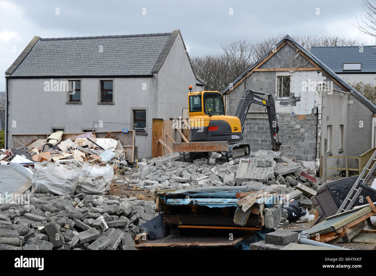 House demolition site with digger and rubble from the demolition Stock ...