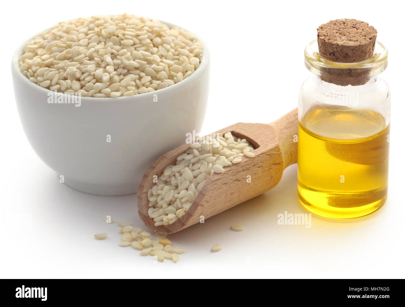 Peeled sesame seeds with oil over white background Stock Photo - Alamy