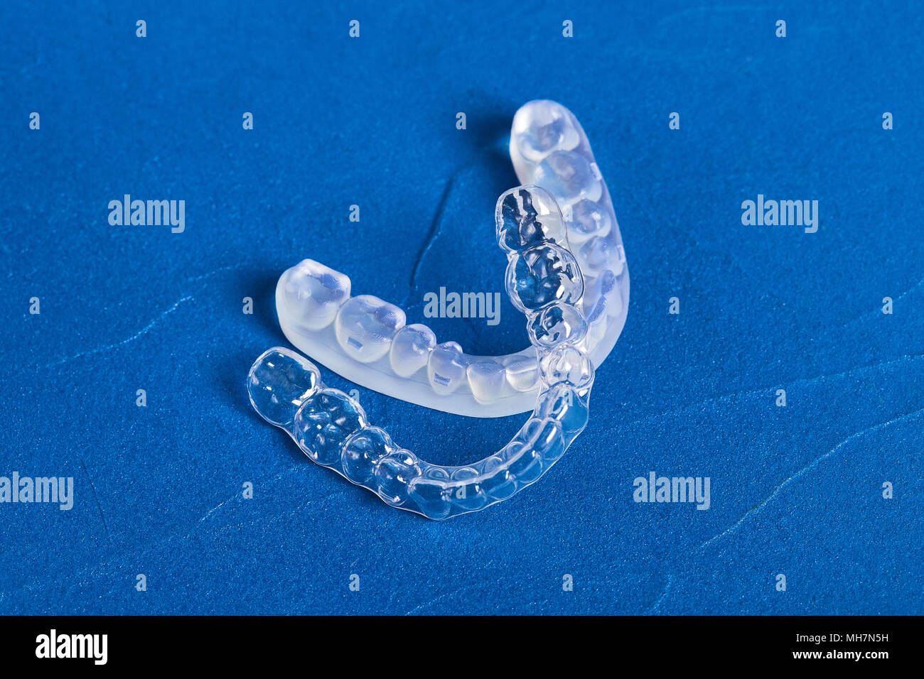 Pre-orthodontic dental trainer alignment appliance on blue background ...