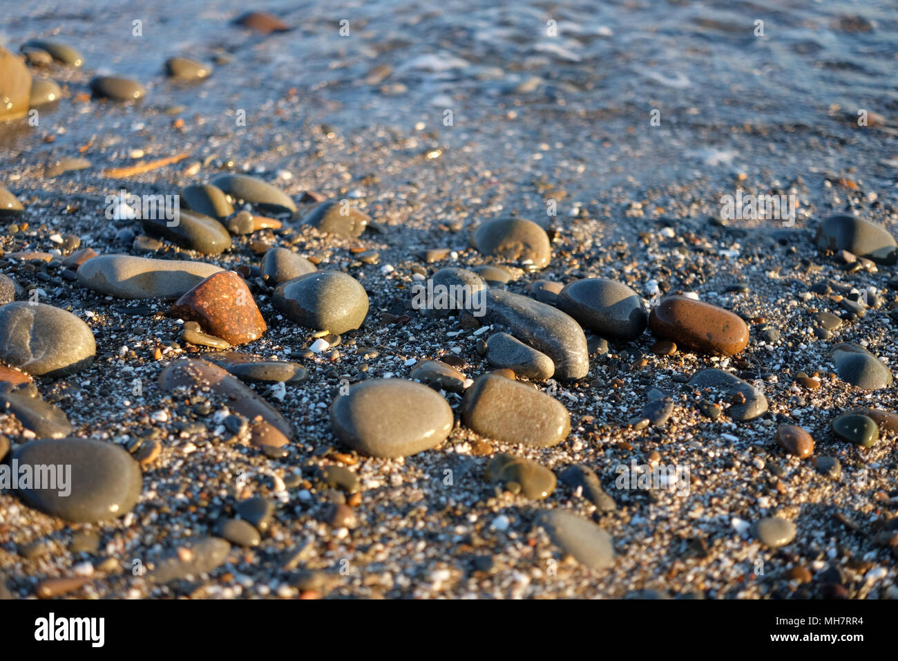 Pebble stones near the sea in bright sunset light background Stock ...