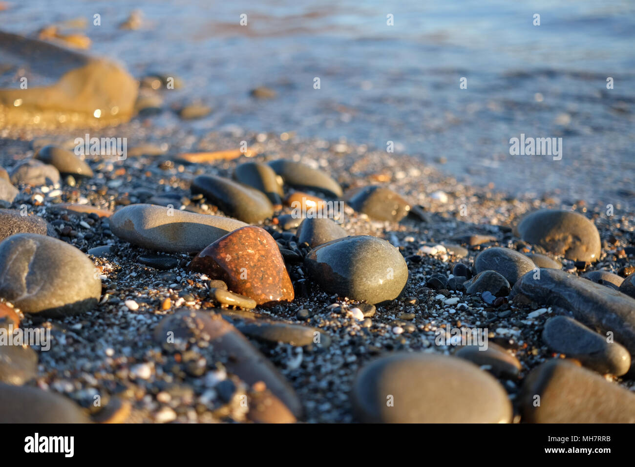 Pebble stones near the sea in bright sunset light background Stock ...
