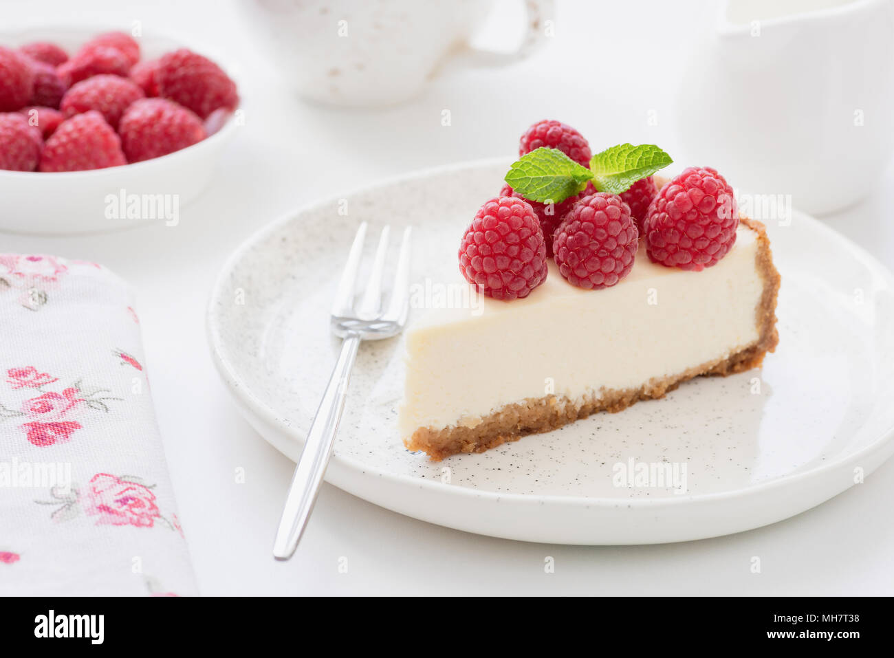Cheesecake slice with raspberries on white plate. Slice of plain ...