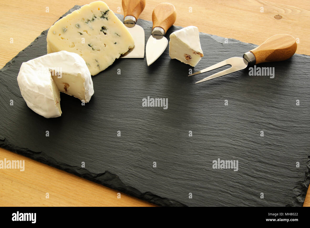 image of dairy products over black stone slate background. Symbols of ...