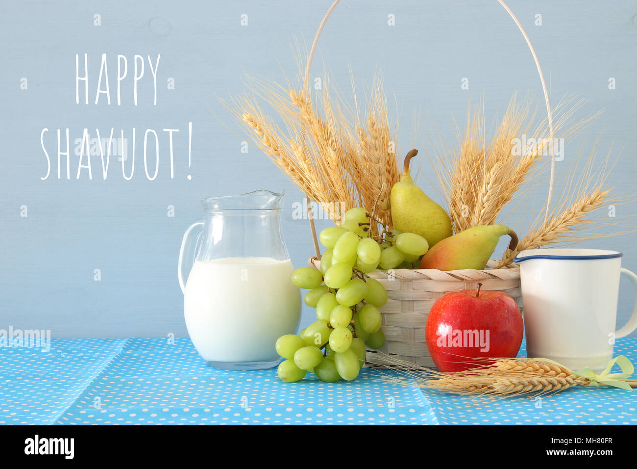 image of milk and fruits over wooden table. Symbols of jewish holiday ...